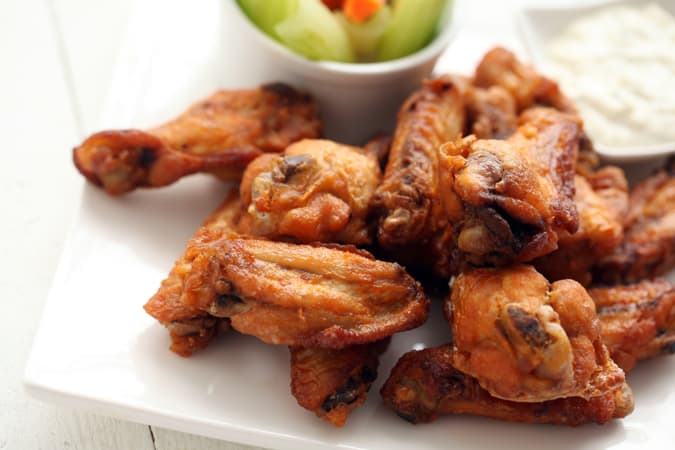 Chicken wings with sauce and vegetables - South Florida Reporter